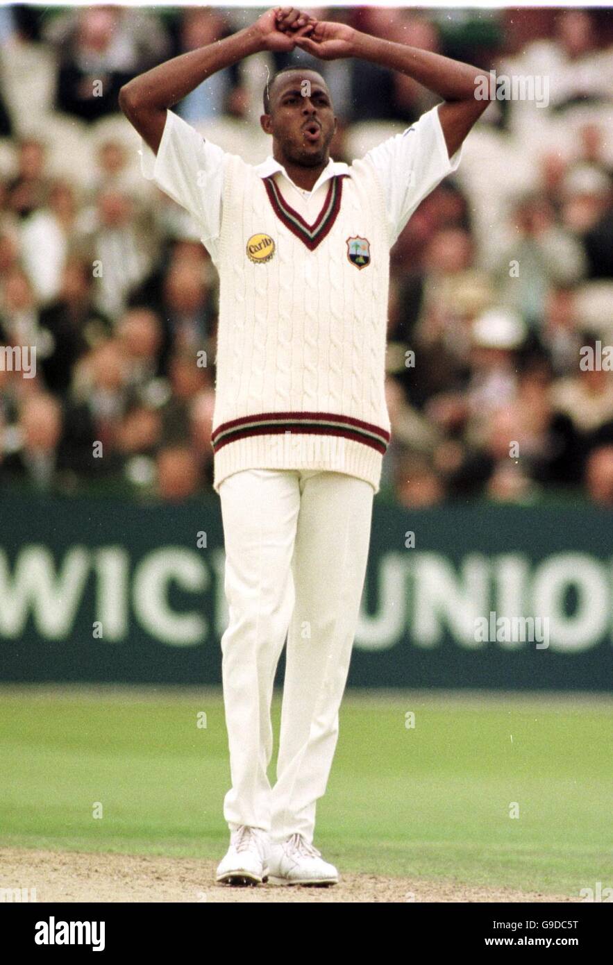 West Indies' Courtney Walsh holds his hands to his head as he fails to ...