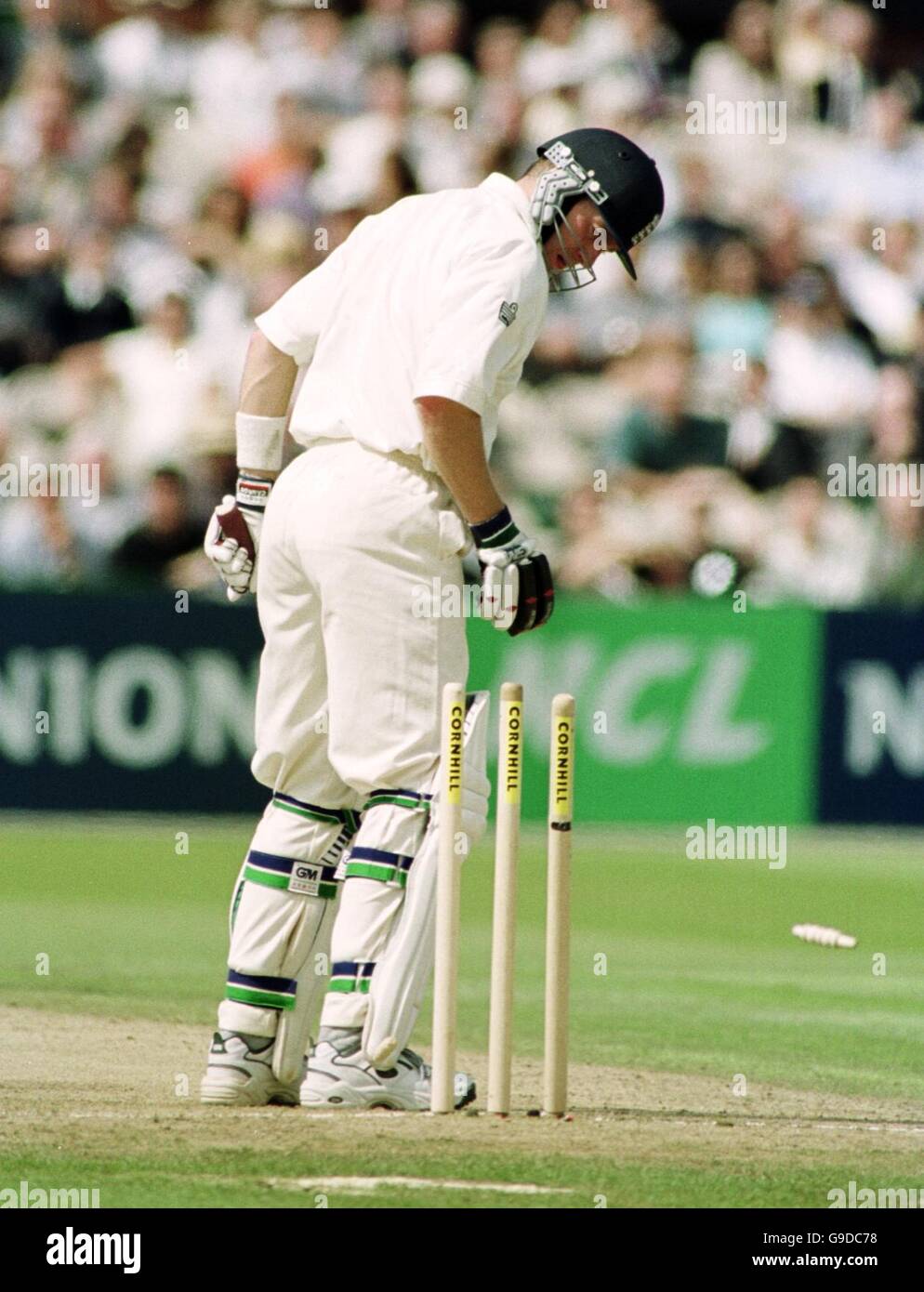 England's Craig White looks back to see the bails flying, courtesy of a ...