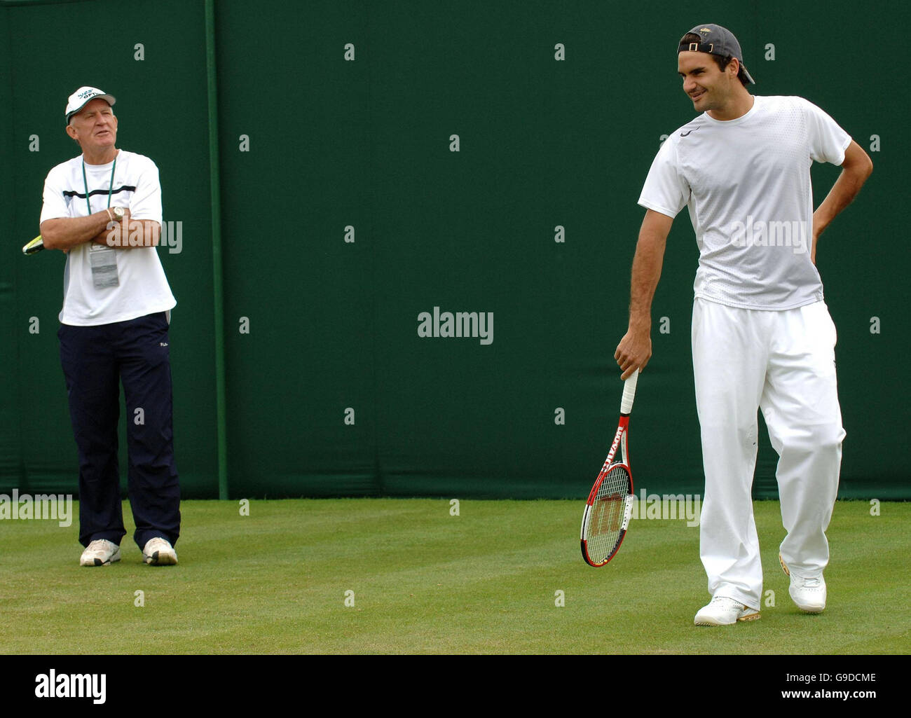 Switzerland's Roger Federer practices as coach Tony Roche (left) looks ...