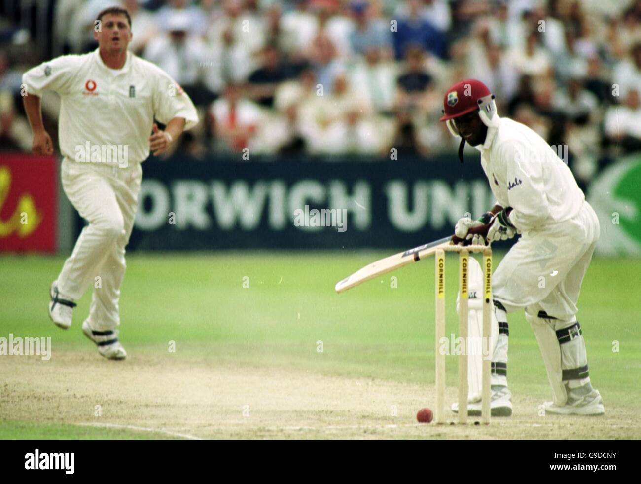 West Indies' Sherwin Campbell (r) looks back at the stumps as he ...