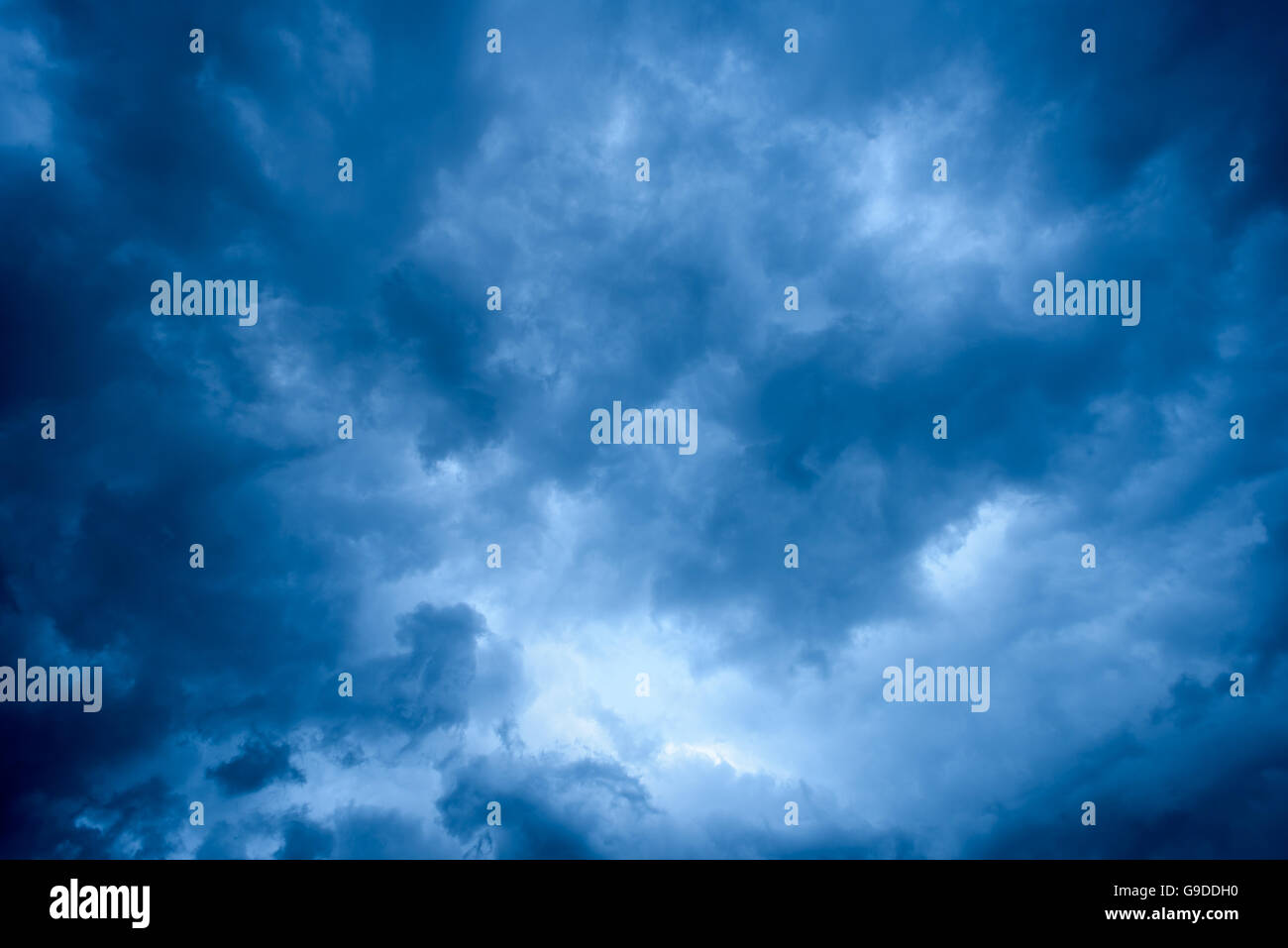 Overhead dark blue storm clouds and white areas and copy space for text ...