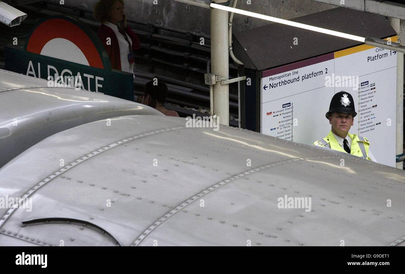 A police officer patrols a platform at Aldgate underground station ...