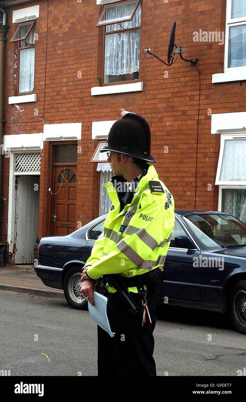 Police stand outside a house in Holmes street, in the Pear Treet ...