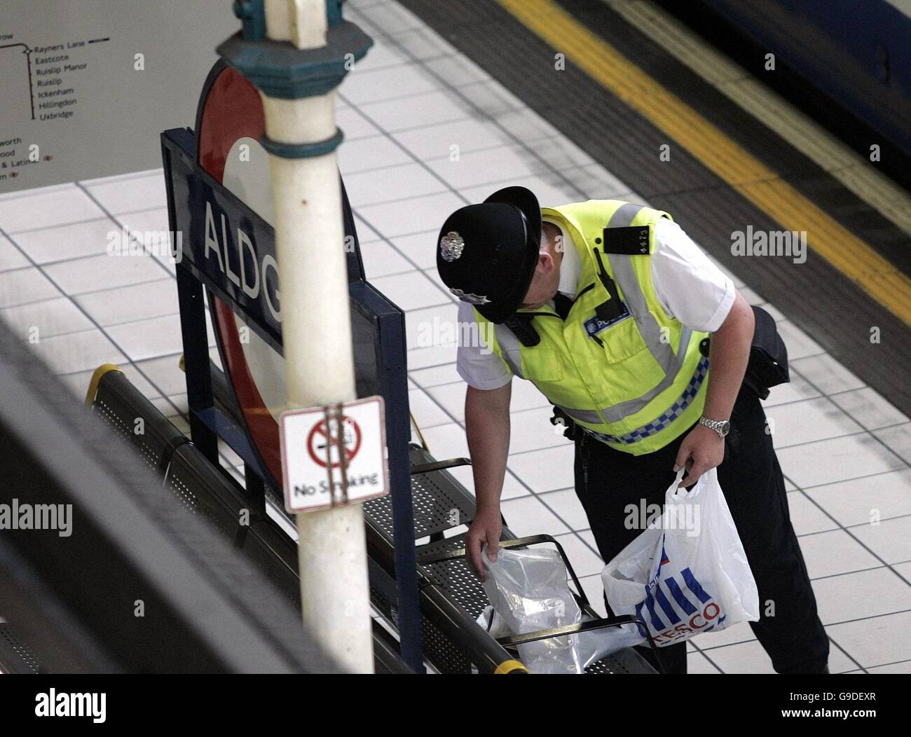 Police officer searches bag on platform at aldgate underground station ...