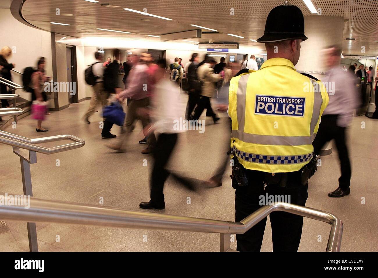 Police officers patrol the concourse which leads to the Piccadilly Line ...