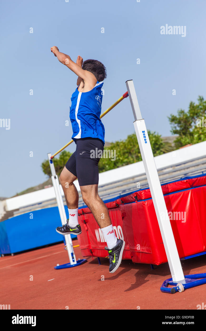 Sports boy performing the high jump on an athletic piste Stock Photo ...