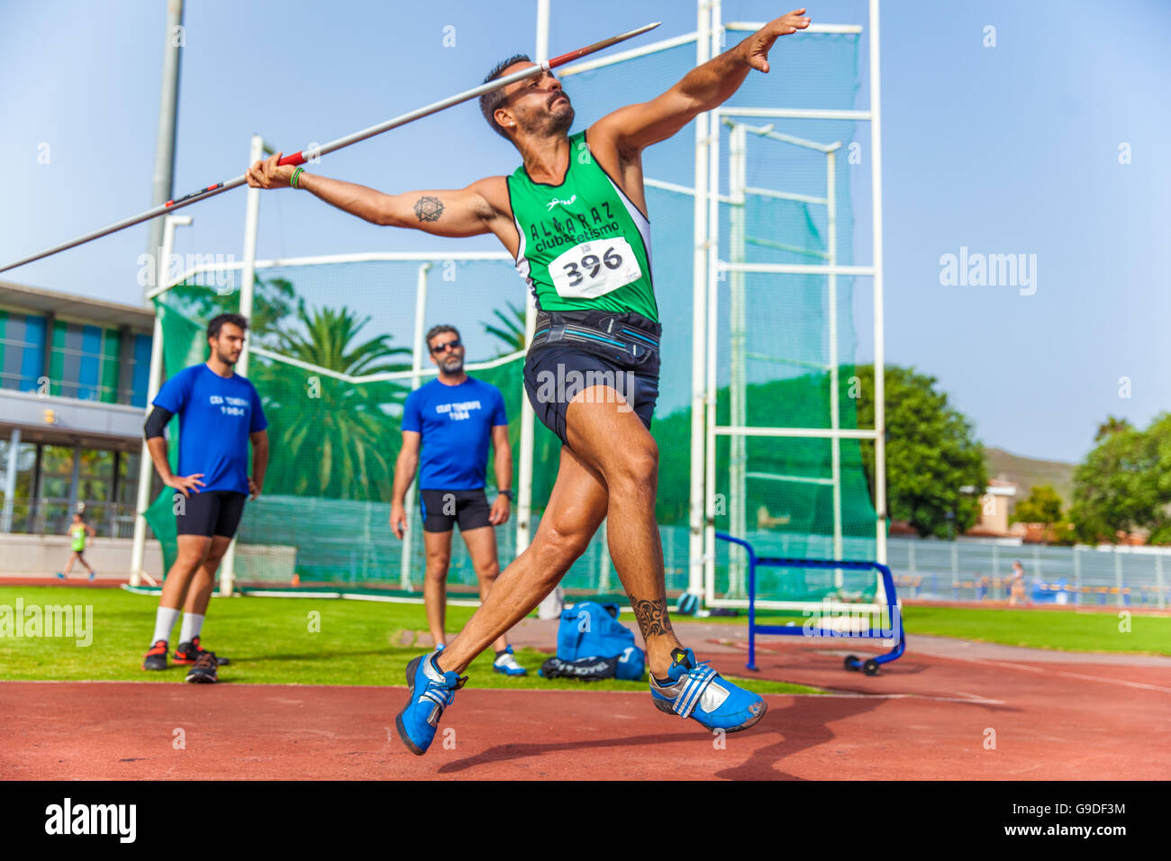 Young sportsman throwing javelin on an athletic piste Stock Photo - Alamy