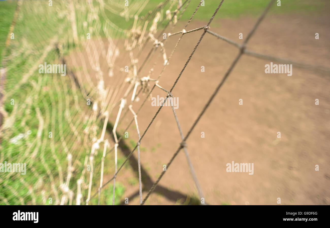 Broken string netting of a football goal. Copy space area for sports ...