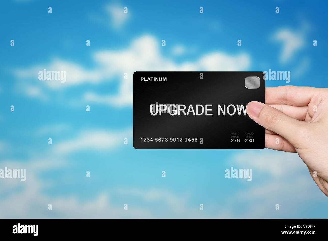 hand picking upgrade now platinum card on blur background Stock Photo ...