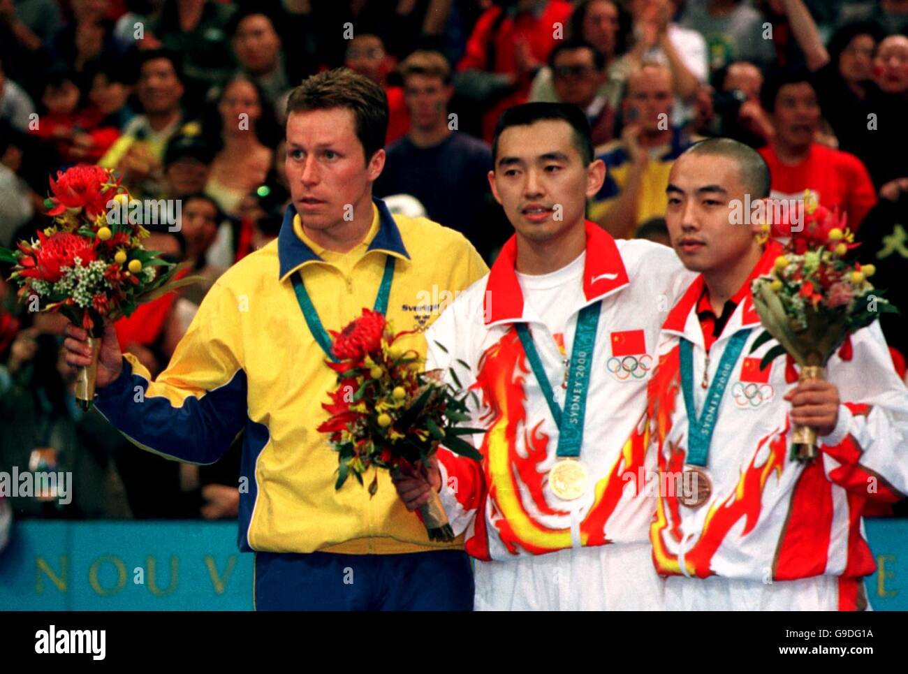 (l-r) Sweden's Silver medalist Jan-Ove Waldner, China's Linghui Kong ...