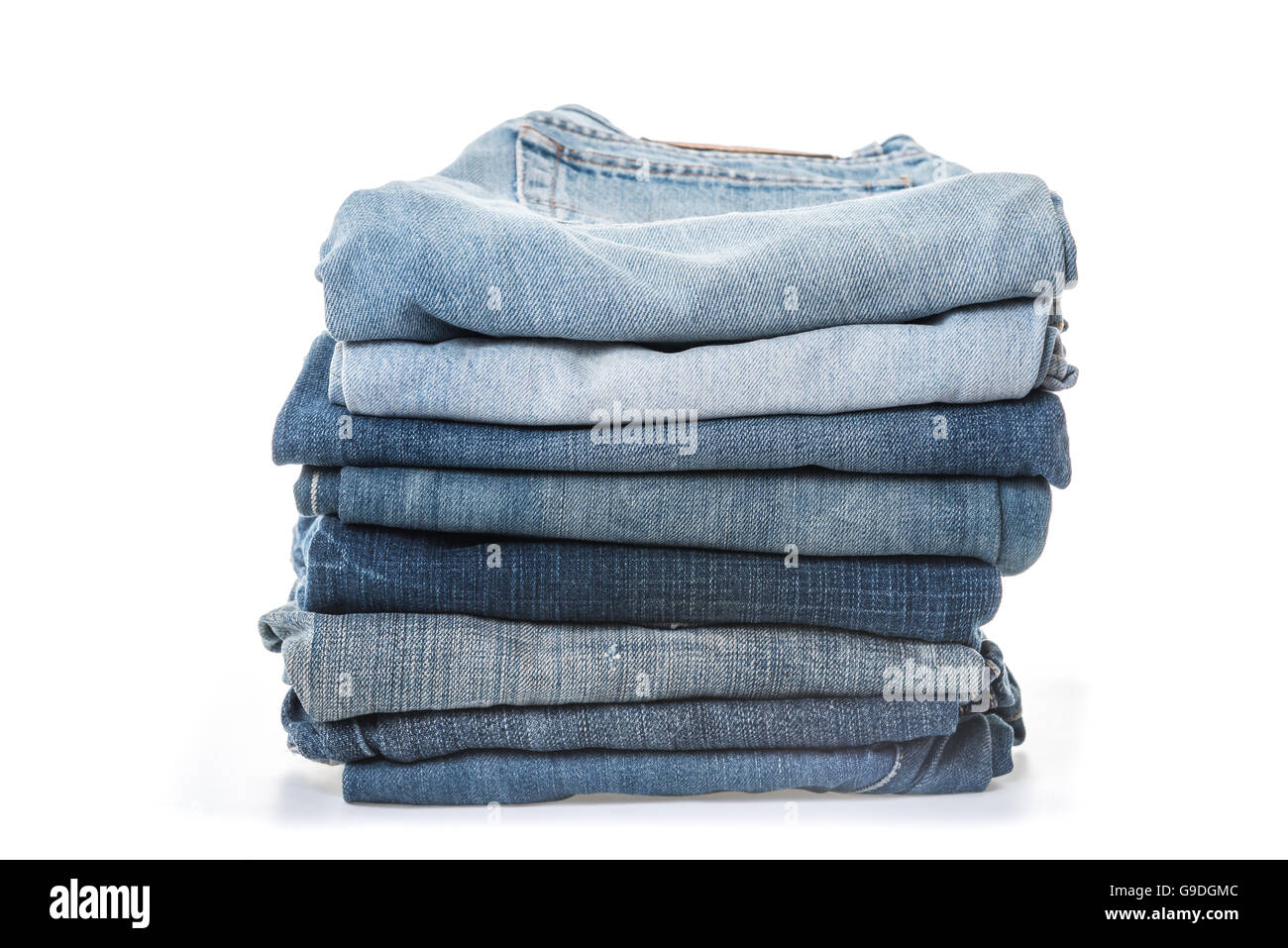 stack of jeans on white background Stock Photo - Alamy