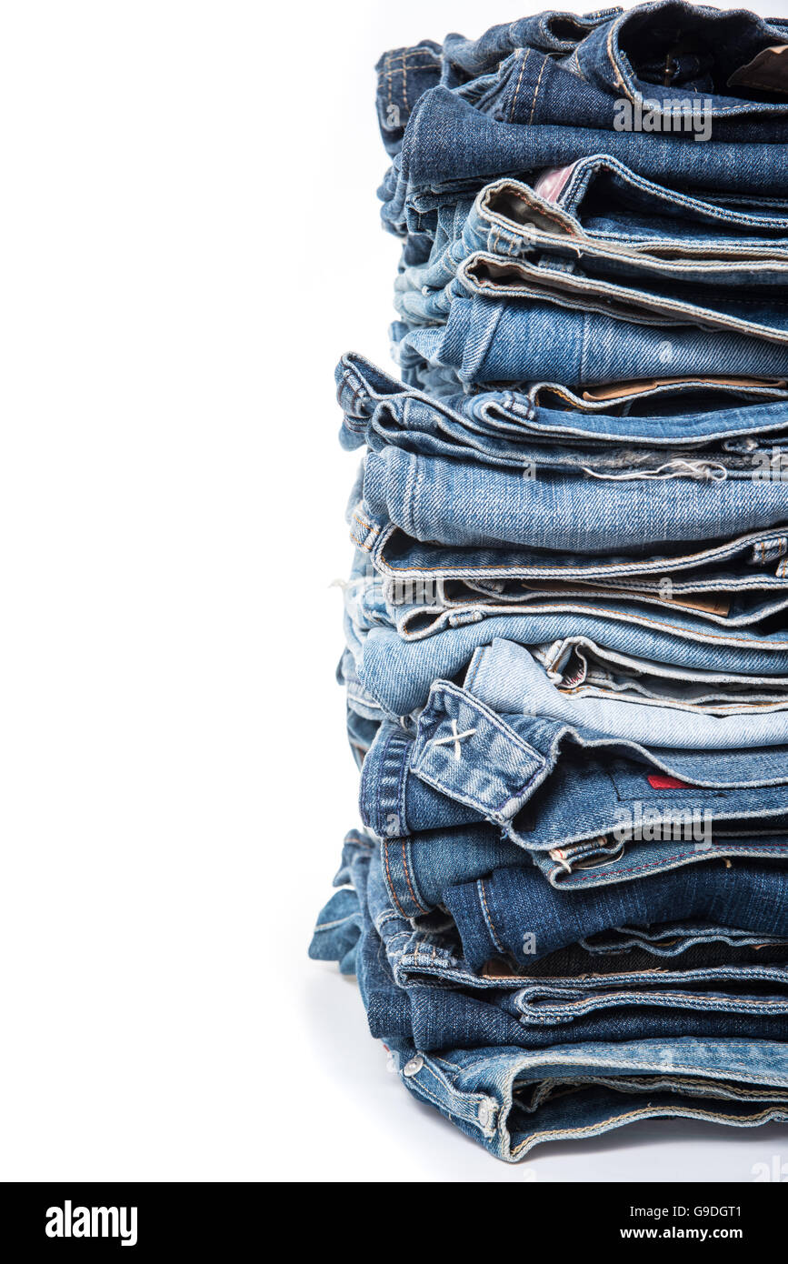 stack of jeans on white background Stock Photo - Alamy