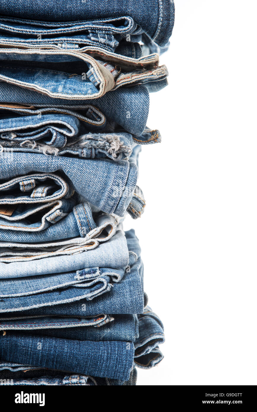 stack of jeans on white background Stock Photo - Alamy