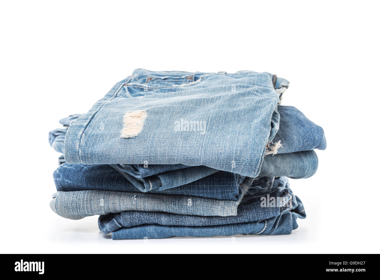 stack of jeans on white background Stock Photo - Alamy
