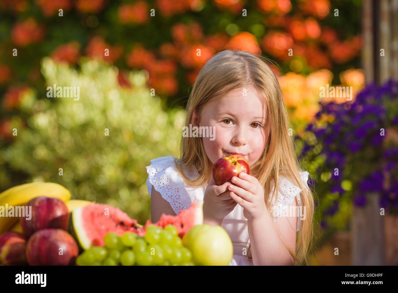 Fruity smile girl eating a vitamin in the form of nectarines Stock ...