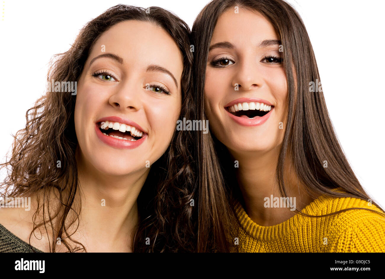Studio portrait of two beautiful girls smiling Stock Photo - Alamy