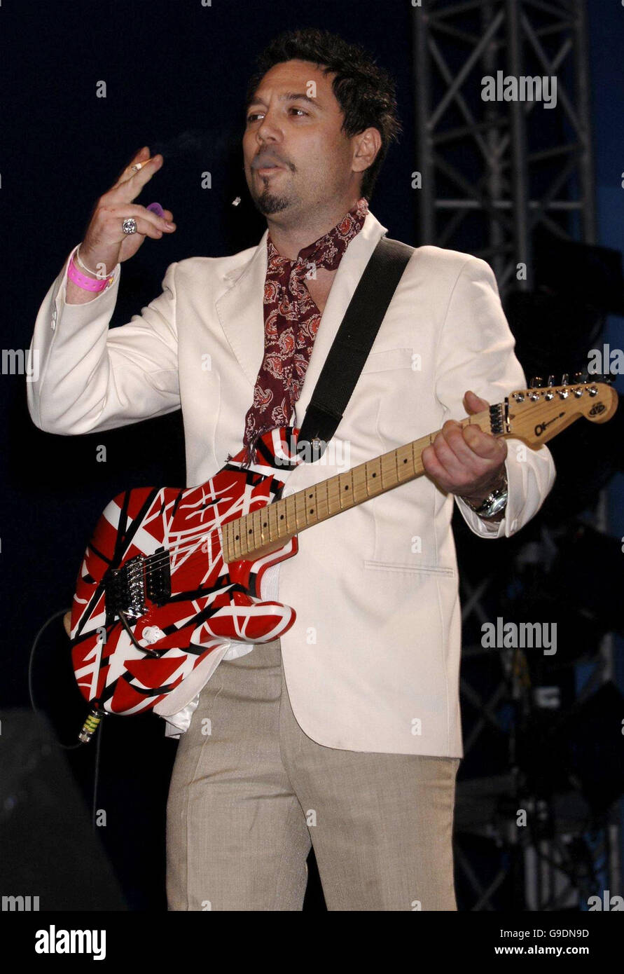Huey from the Fun Lovin' Criminals smokes a cigarette on stage during ...