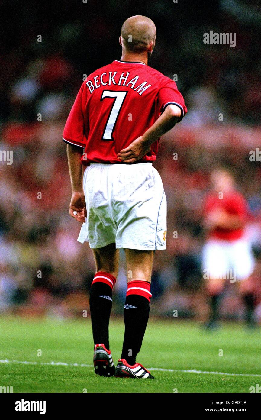 Manchester United's David Beckham holds his back before going off ...