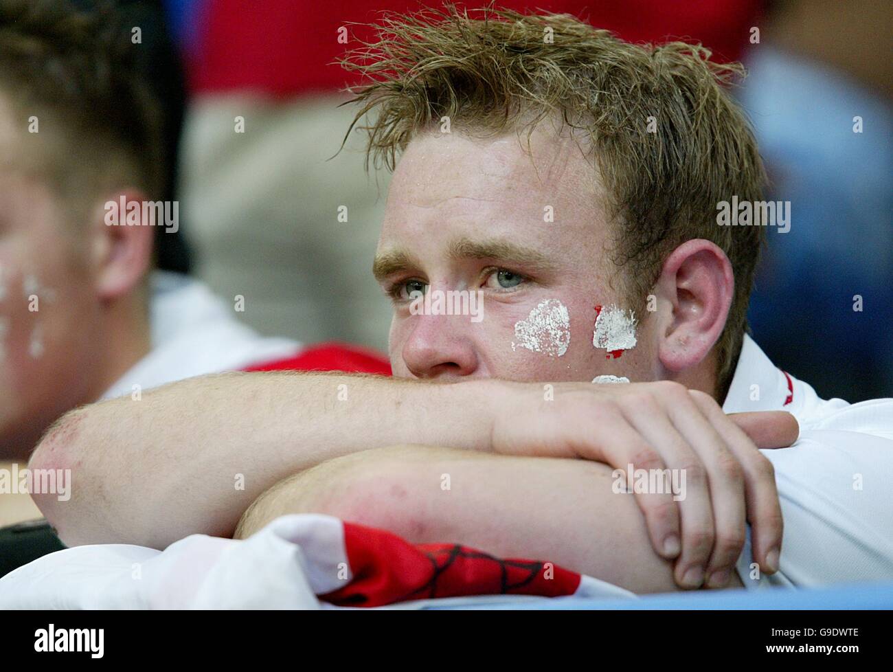 An England fan sits dejected at the final whistle after his side lost ...