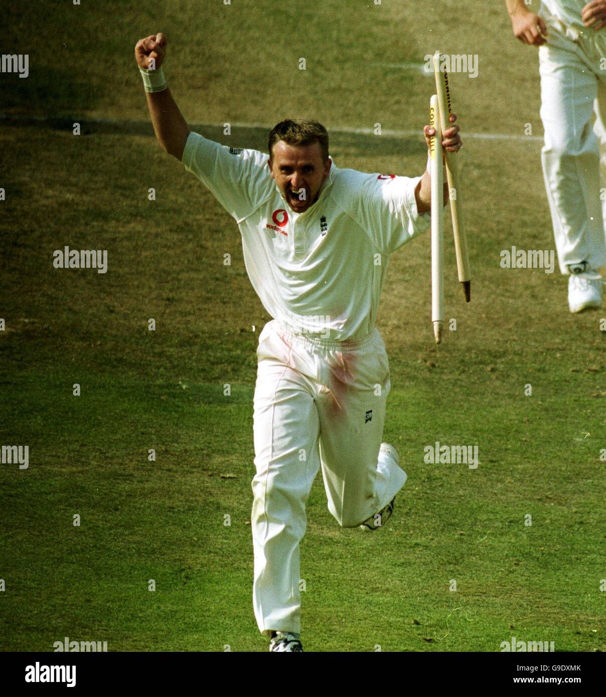 England's Dominic Cork runs from the pitch with two stumps as England ...