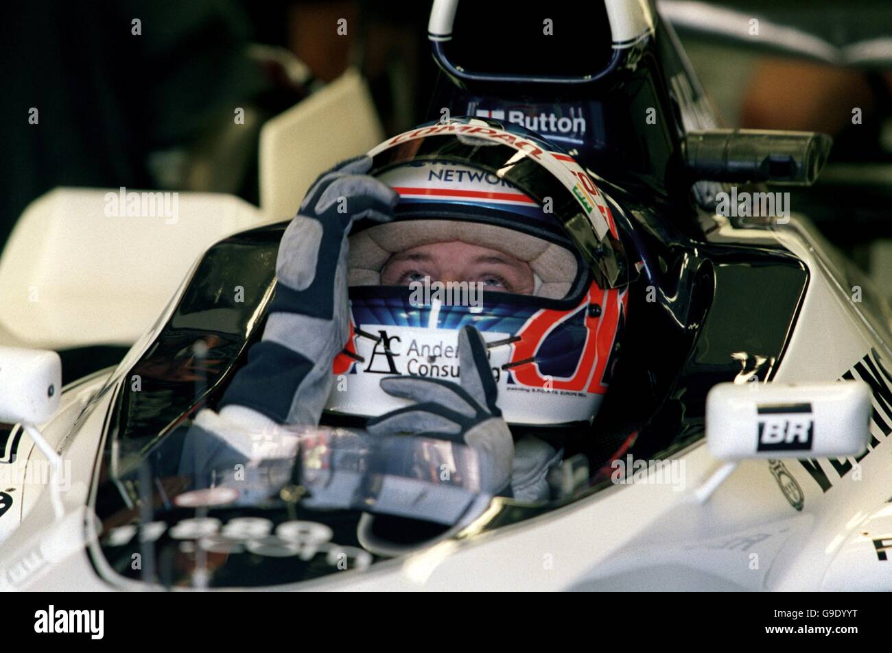 Jenson Button watches the timing monitor before setting 12th fastest ...