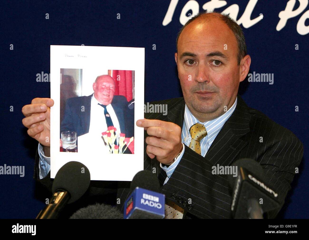 Detective Superintendent Steve Wade holds up a picture of Peter Purcell ...