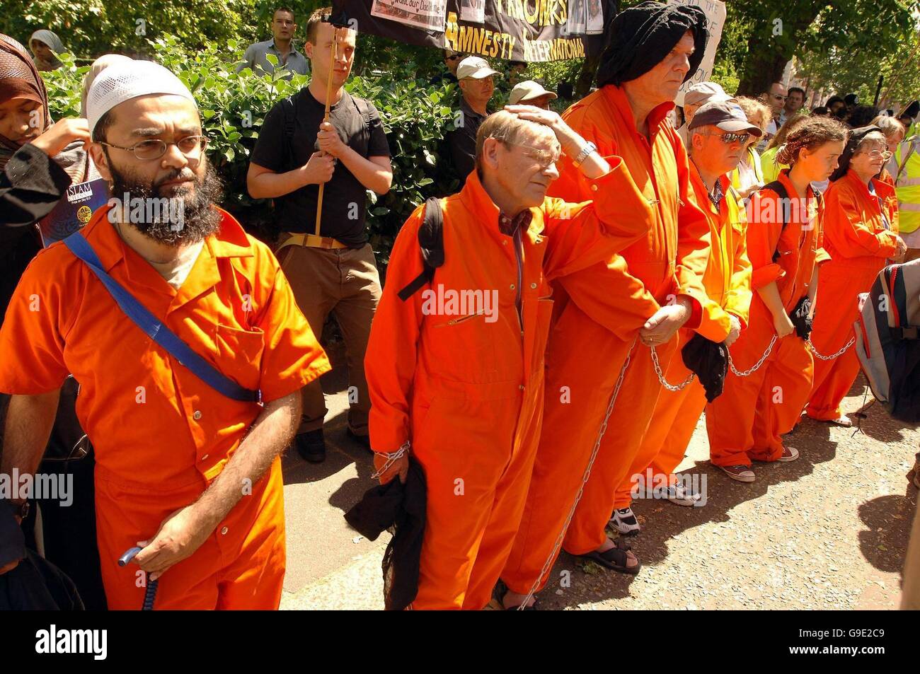 Guantanamo demonstration in London. A group of boiler-suit-wearing men ...