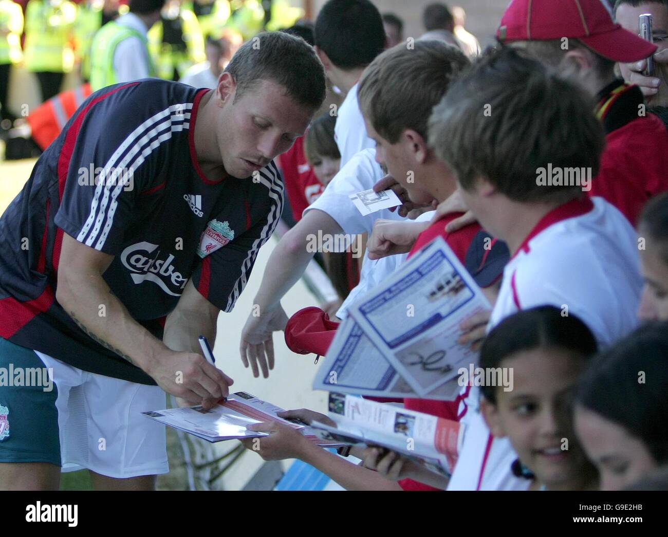 Liverpool's Craig Bellamy signs autographs following his substitution ...