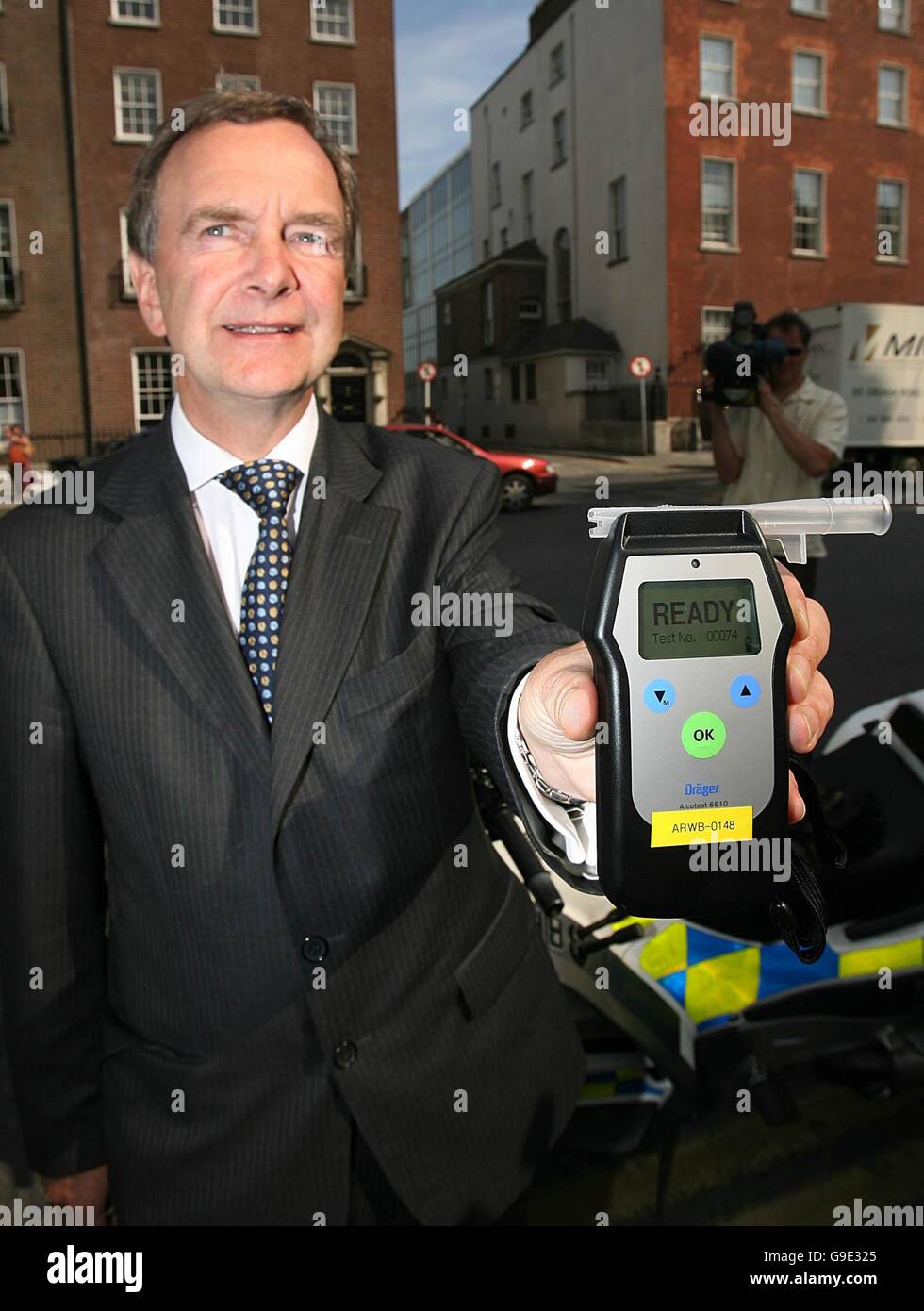 Irish Transport Minister Martin Cullen holds a breathalyser outside ...