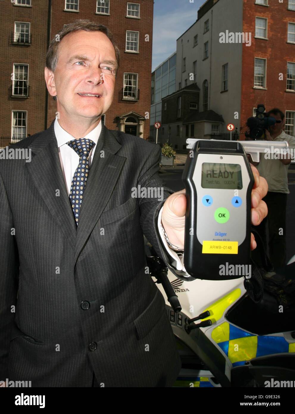 Irish Transport Minister Martin Cullen holds a breathalyser outside ...