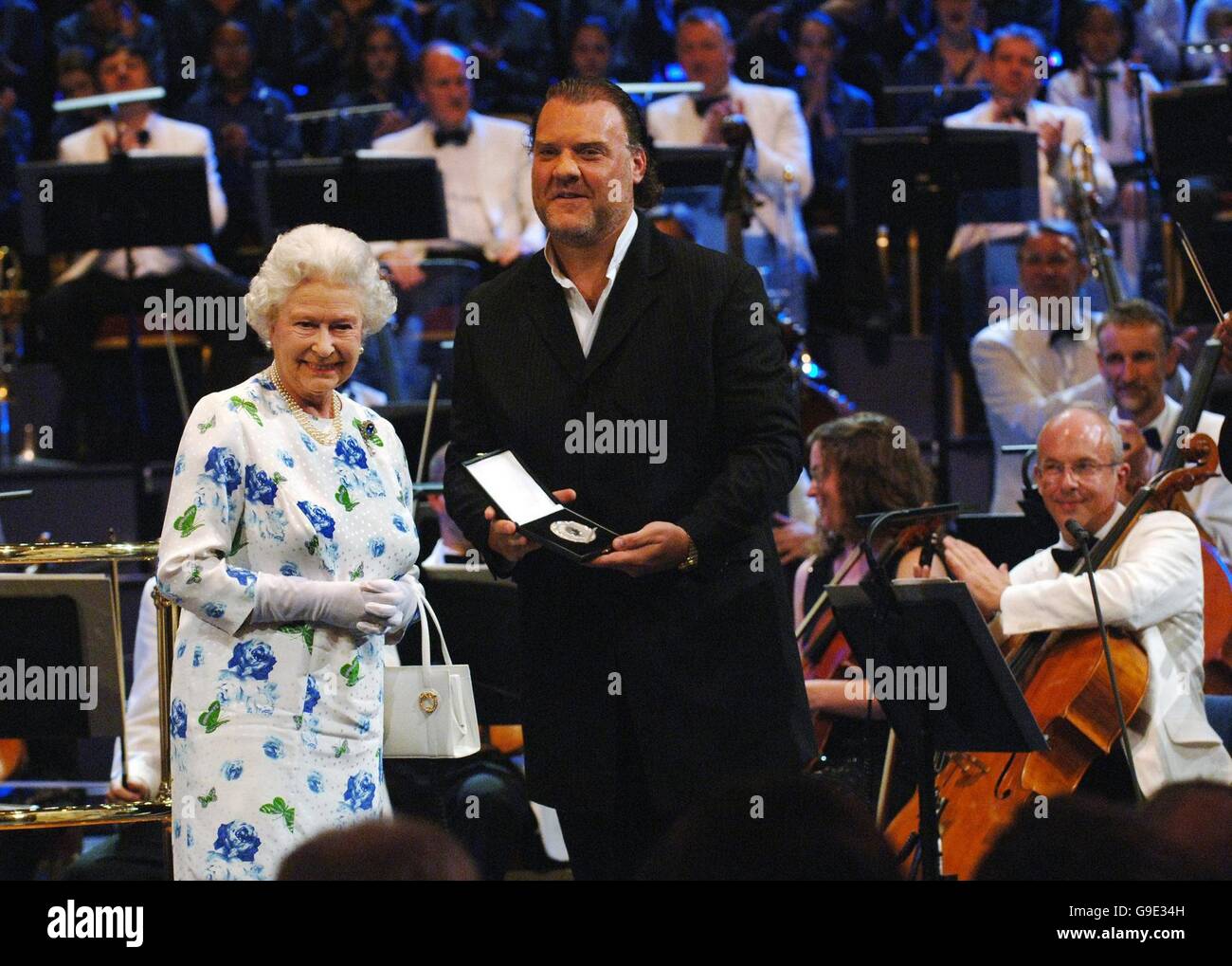Britain's Queen Elizabeth II (left) presents The Queen's Medal for ...