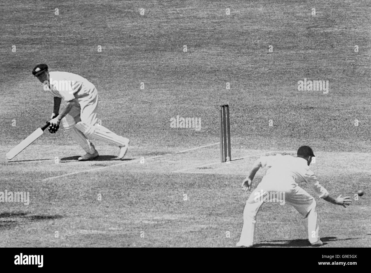 Australia's Keith Miller (l) flicks the ball past England's John Ikin ...