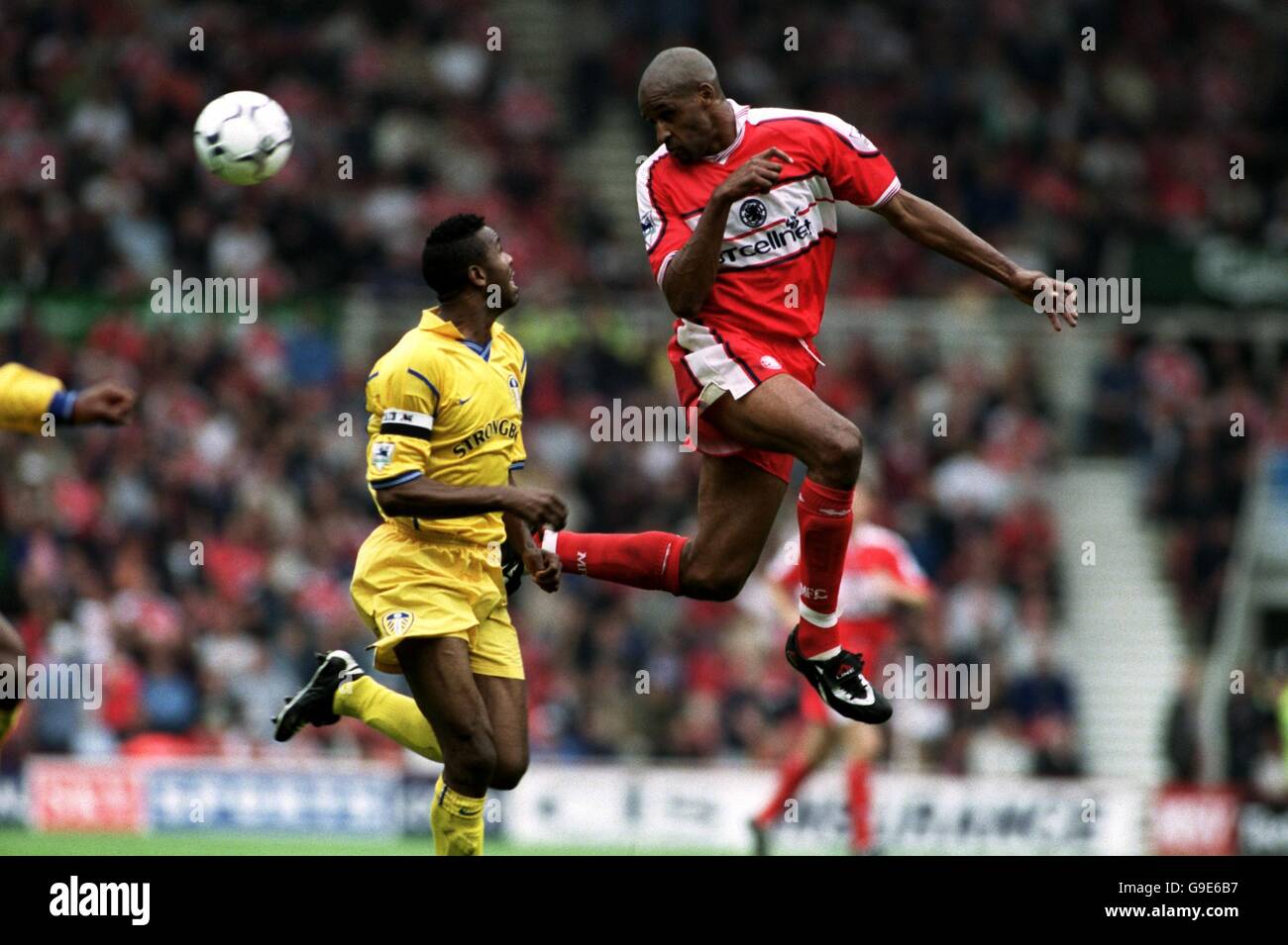 Middlesbrough's Brian Deane heads the ball away from the Leeds United's ...