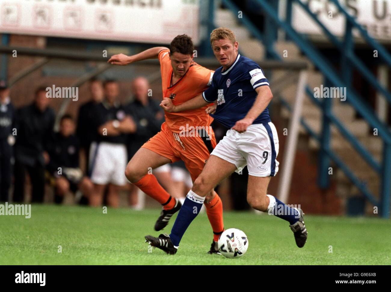 (L-R) Barnet's Mark Arber has his shirt pulled by Chesterfield's David ...