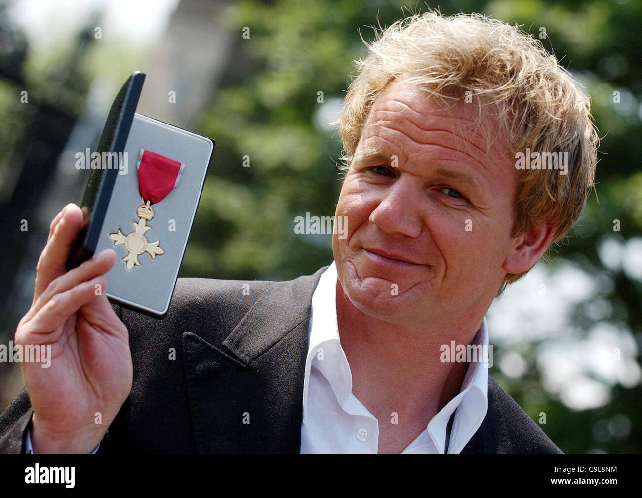 Celebrity chef Gordon Ramsay holds his OBE in the grounds of ...