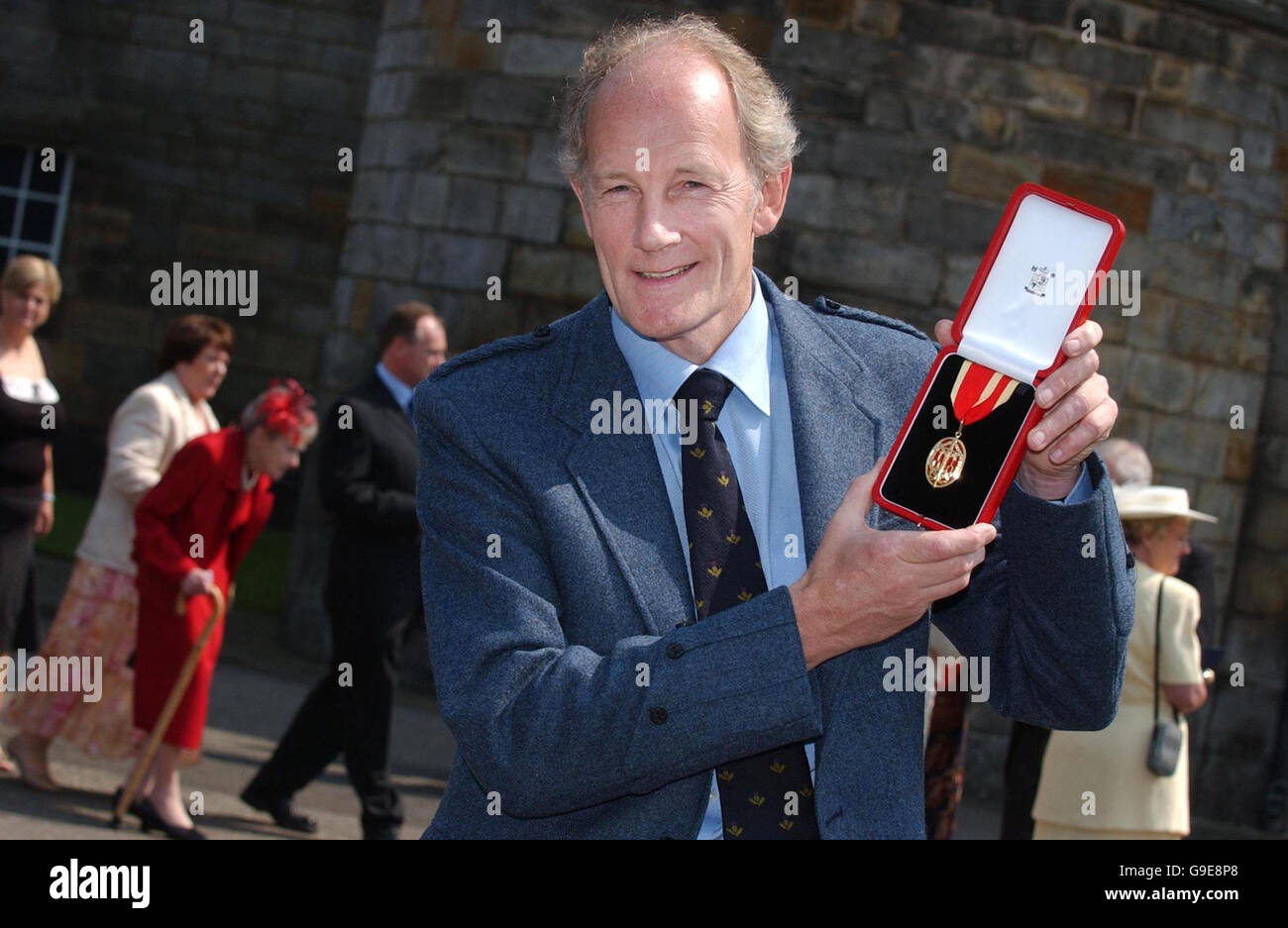 Billy Gamell holds his knighthood in the grounds of Holyroodhouse ...