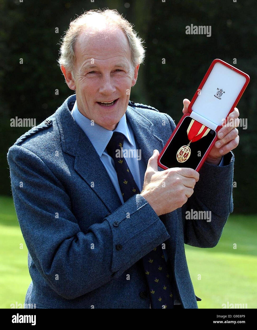 Billy gamell holds his knighthood in the grounds of holyroodhouse hi ...