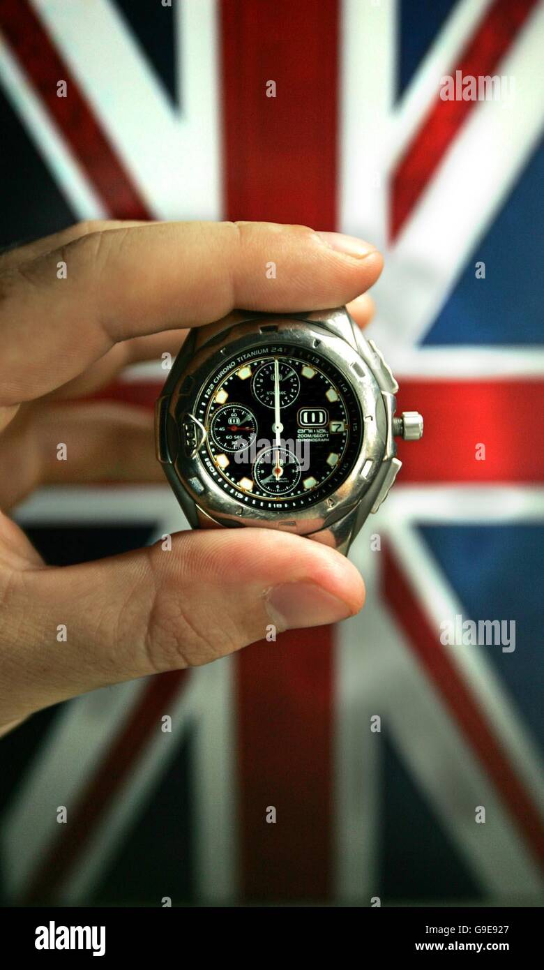 A clock/watch in front of a Union Jack.. A clock/watch in front of a ...