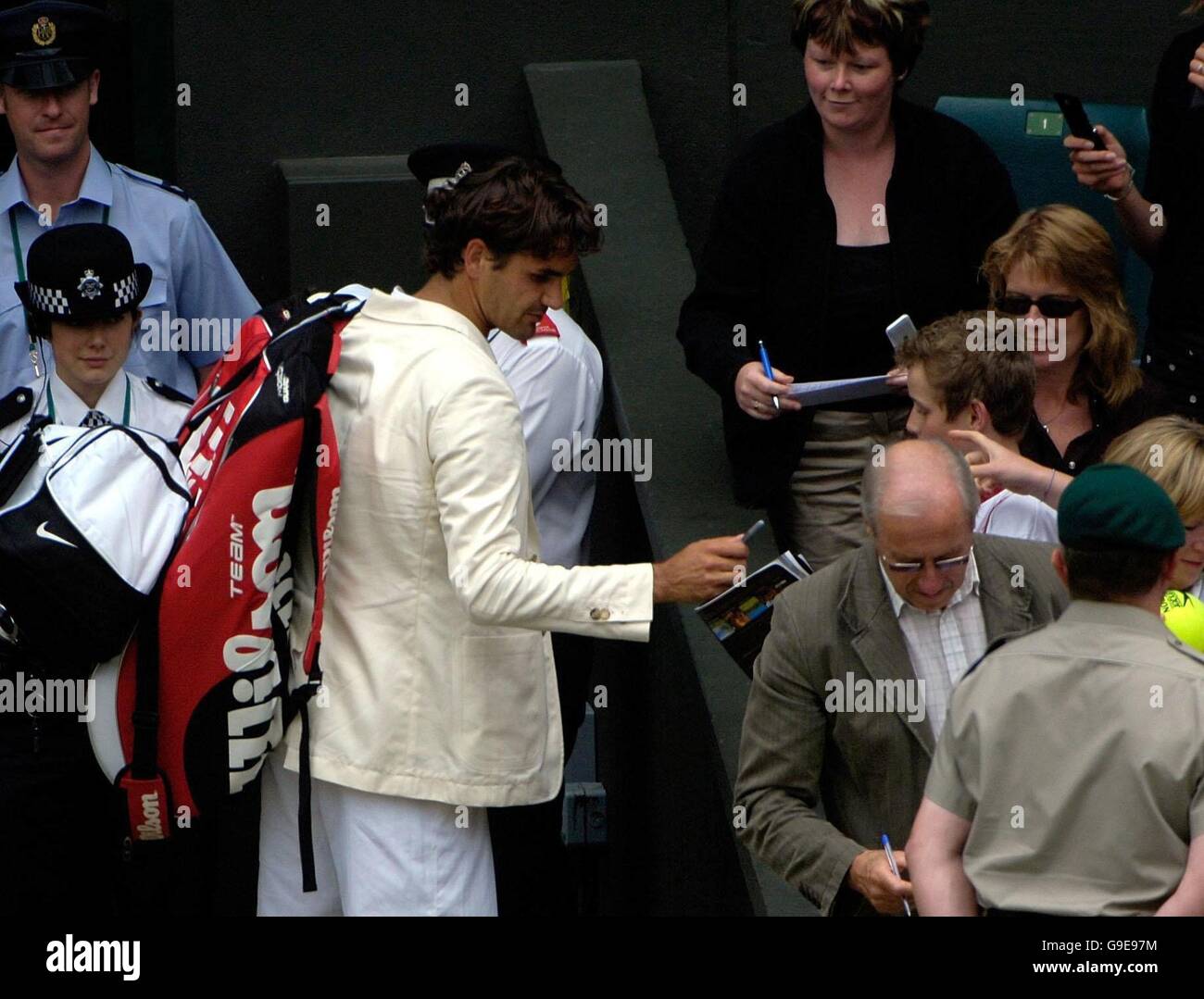 Switzerland's Roger Federer signs autographs as he leaves court ...