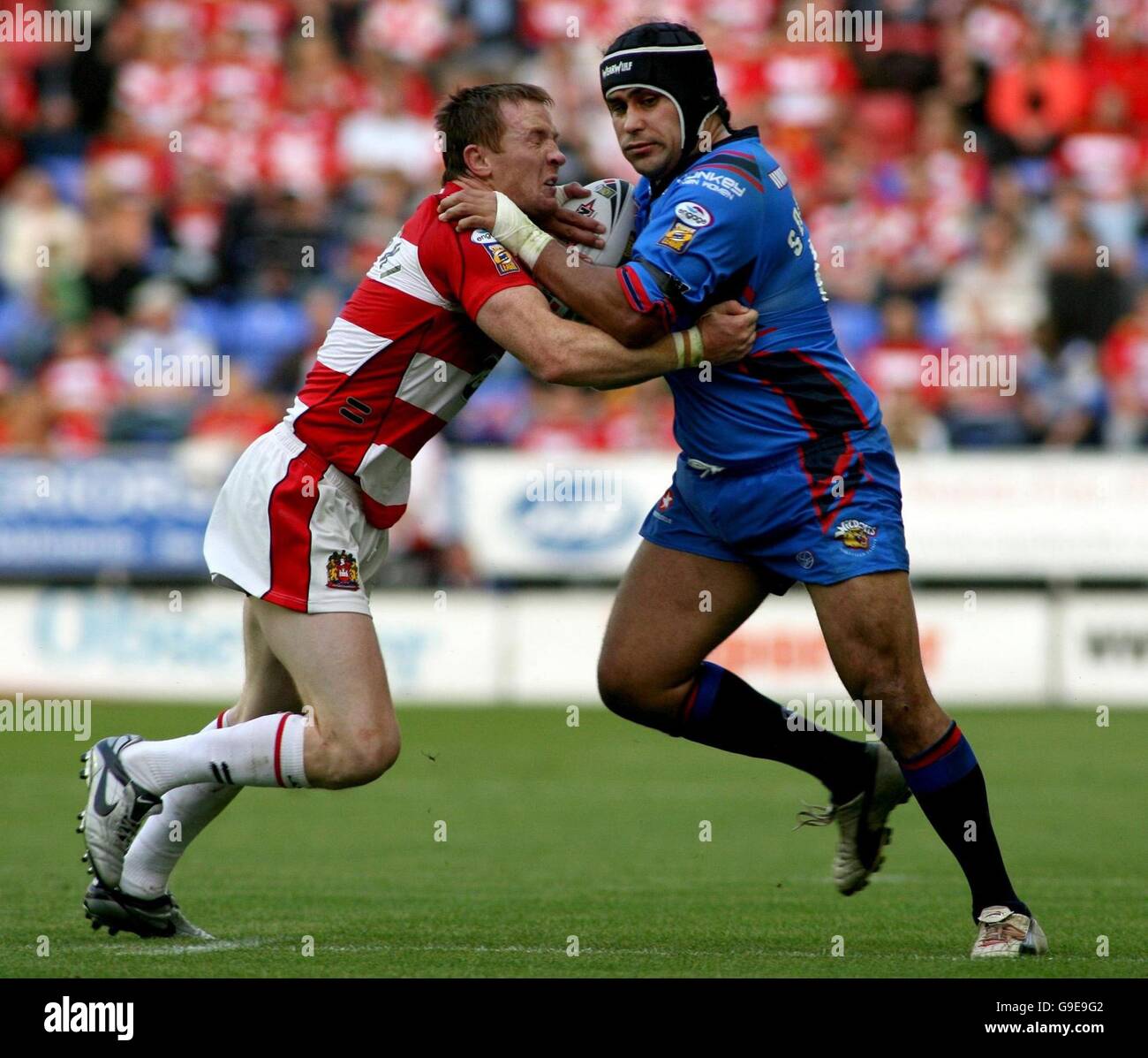 Wigan's Kris Radlinski (L) tackles Wakefield's David Solomona during ...