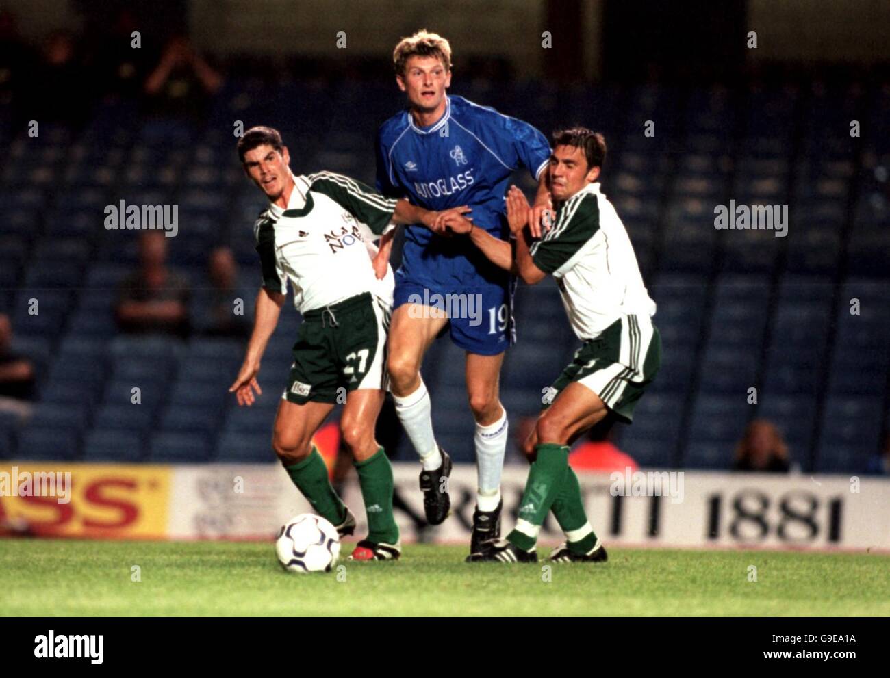 Chelsea's Tore Andre Flo (c) is held back by a combination of St Gallen ...