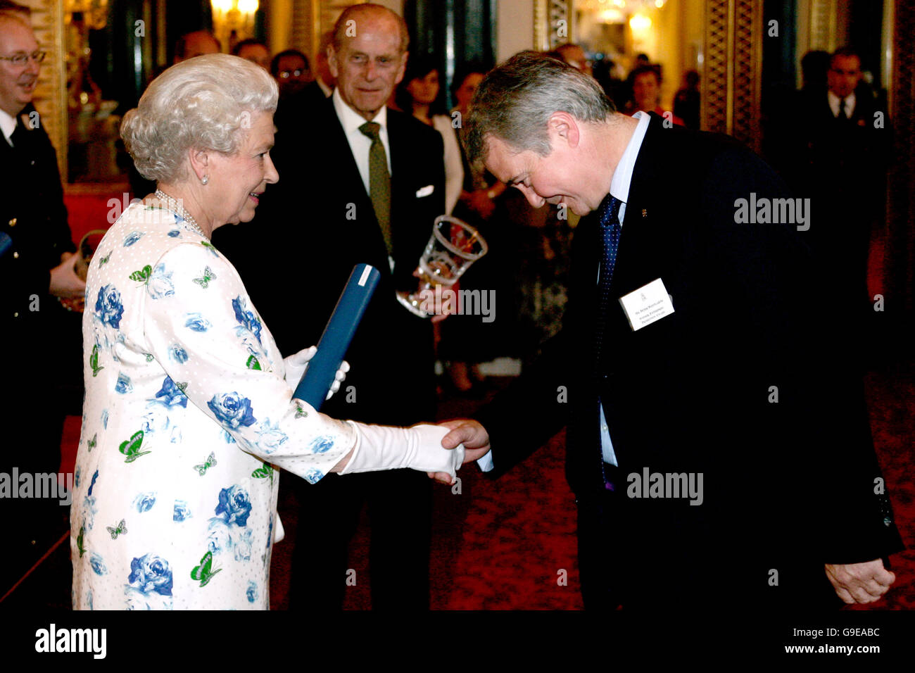 Britain's Queen Elizabeth II presents an award for enterprise to Peter ...