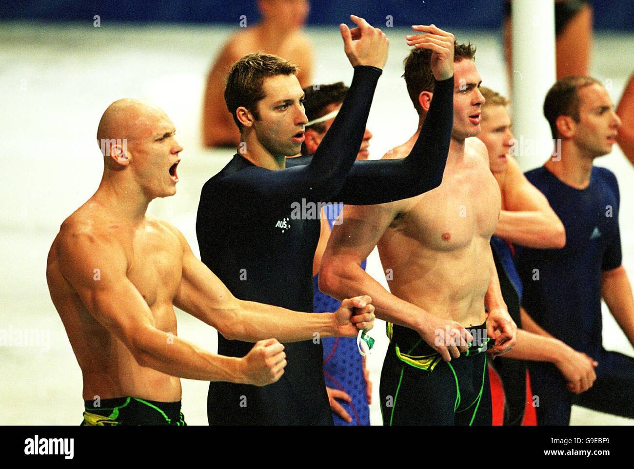 L-R; Australia's Michael Klim, Ian Thorpe and Todd Pearson cheer their teammate William Kirby ...