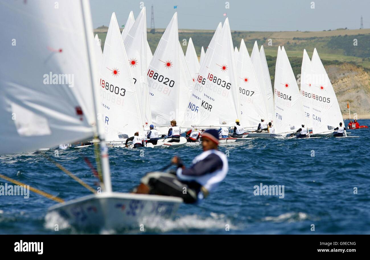 The boy's Laser class cross the start line at the Volvo Youth Sailing ...