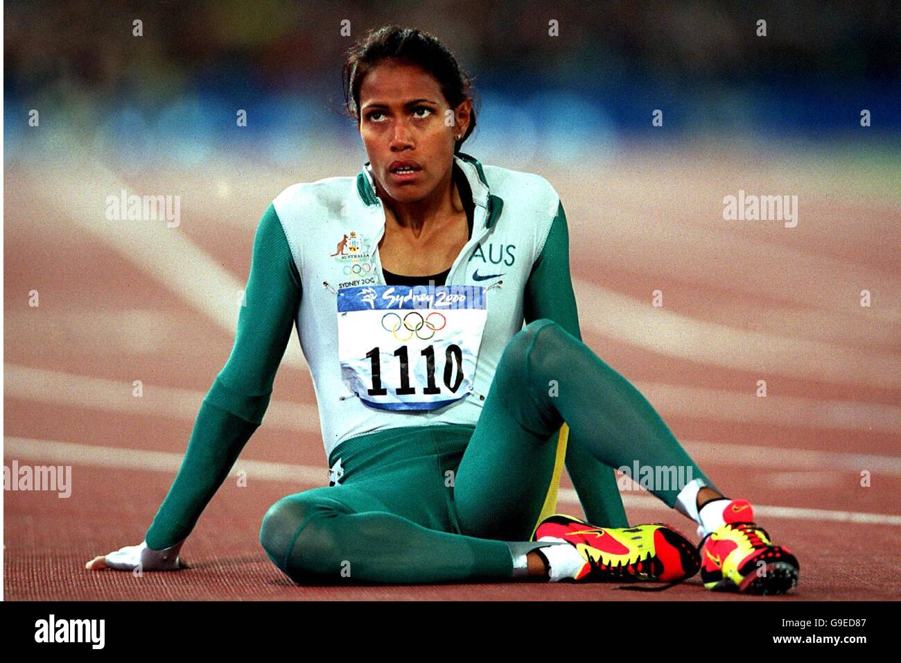 Australias cathy freeman sits exhausted after winning a gold medal hi ...
