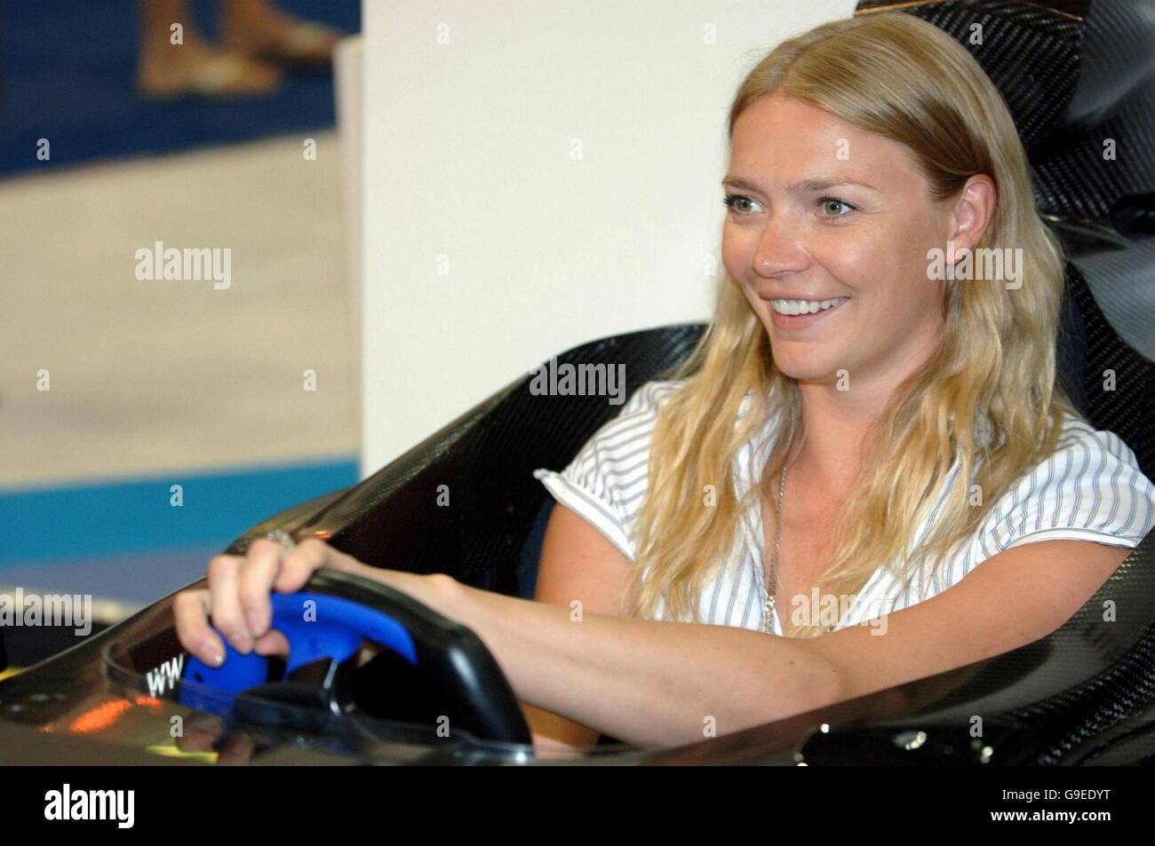 Model Jodie Kidd tries out a racing car simulator, as she attends the ...