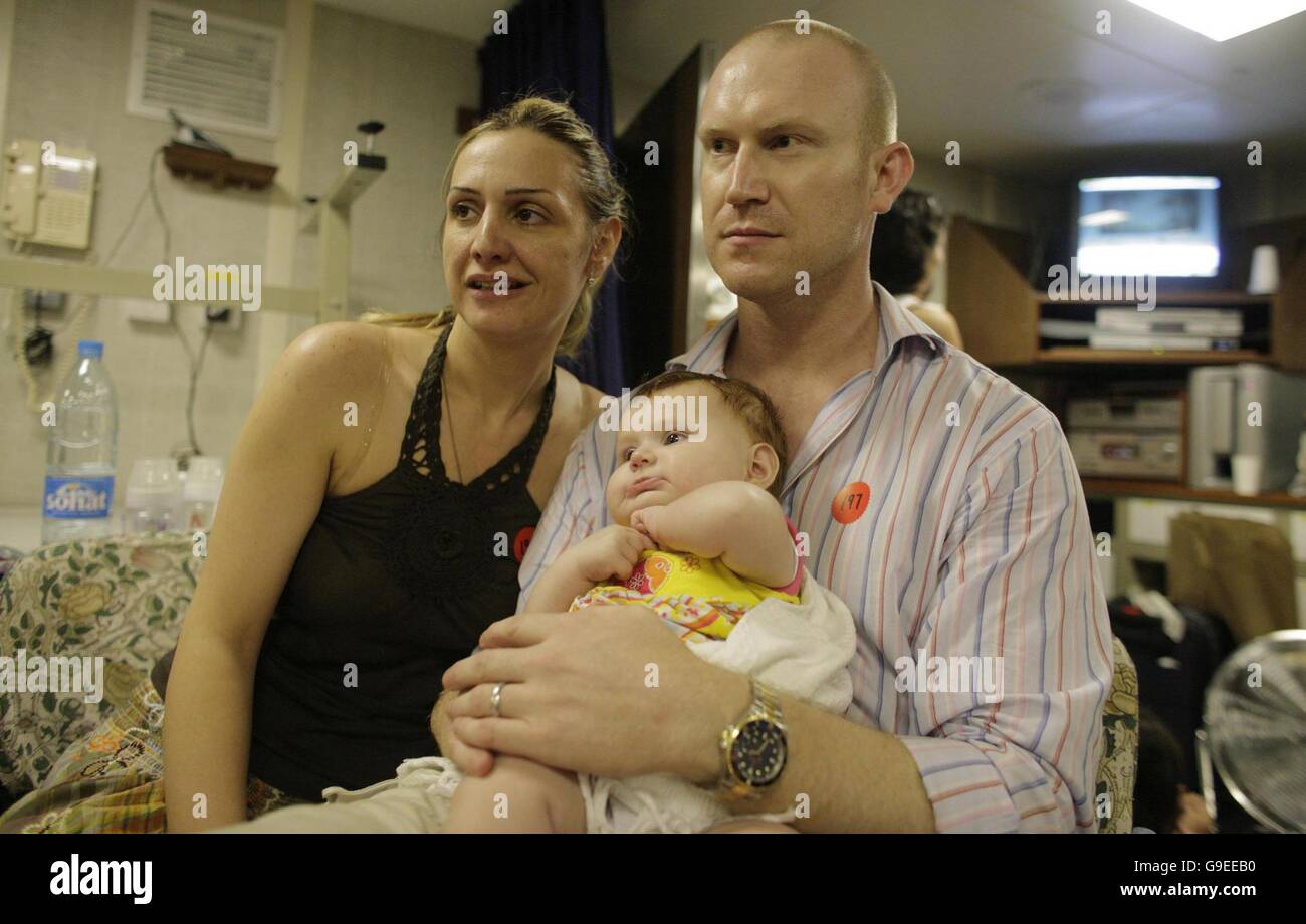 John McKean (34) holds his daughter Zoe (4 months) as they are ...