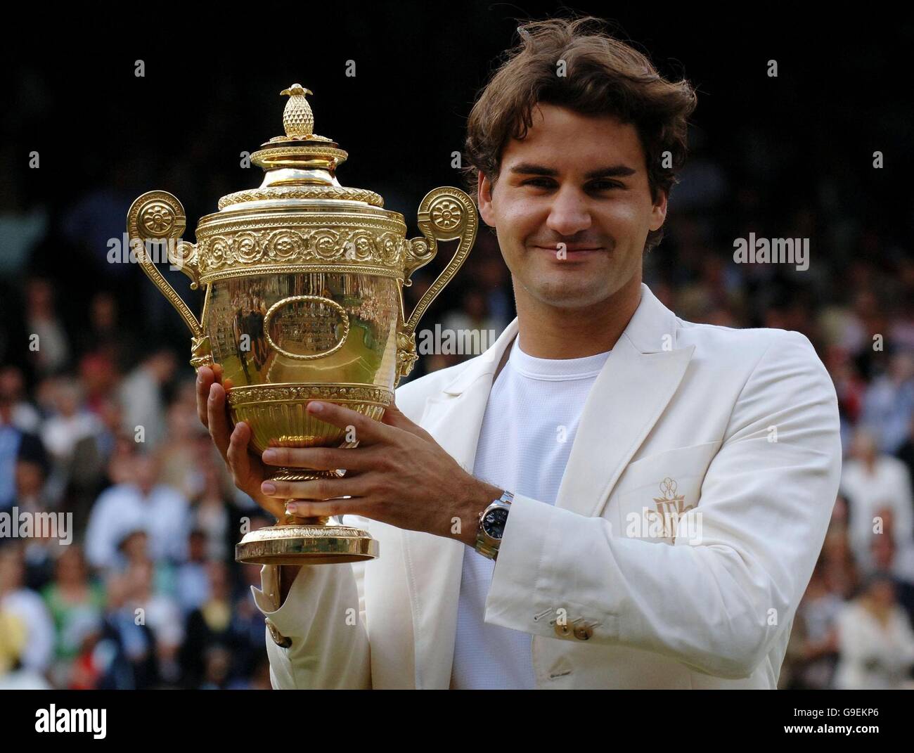 Switzerland's Roger Federer celebrates with his trophy after defeating ...