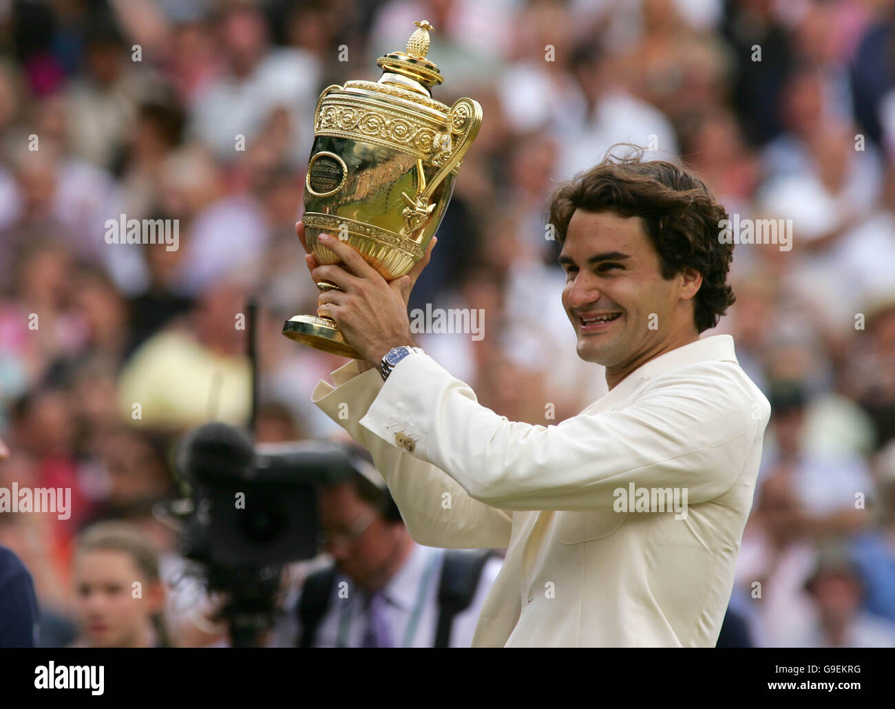 Switzerland's Roger Federer celebrates with the trophy after beating ...