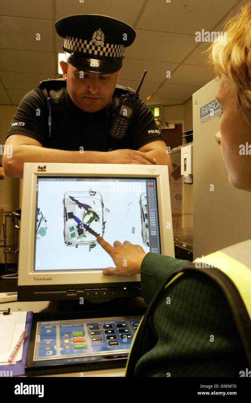 Police monitor knives passing through an x-ray machine at Glasgow ...